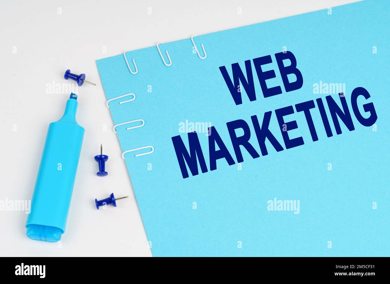 Economic concept. On a white surface, a marker, buttons and a blue ...