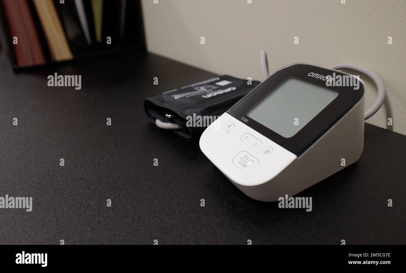 A blood pressure machine sits on the countertop of a medical exam room ...