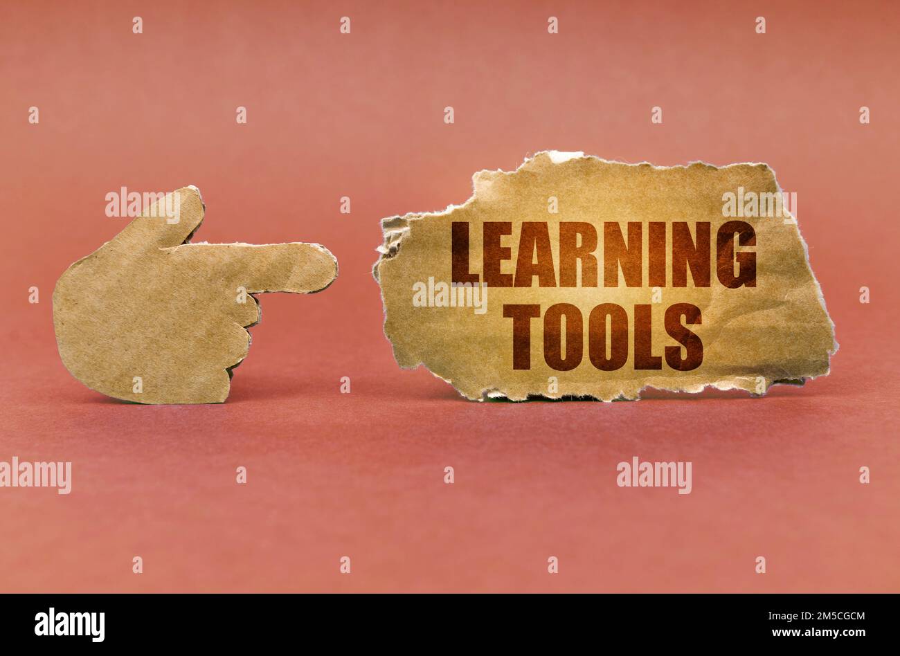Business and education concept. On a brown surface, a cardboard hand ...