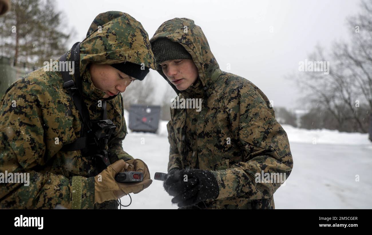 U.S. Marine Corps Lance Cpl. Anthony Zheng (left), a data systems ...