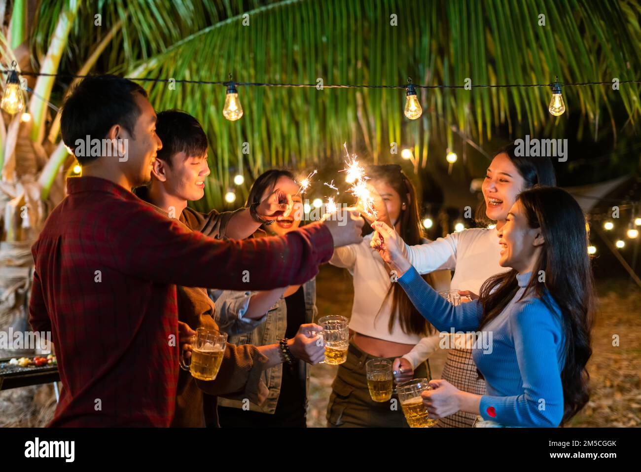Asian young party people happily hold sparkles in celebration Stock ...