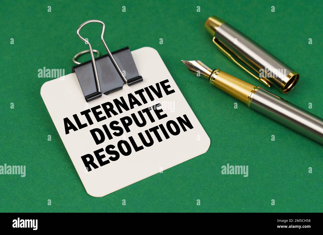 Business and industry concept. On a green surface, a pen and a sheet of paper with the ...