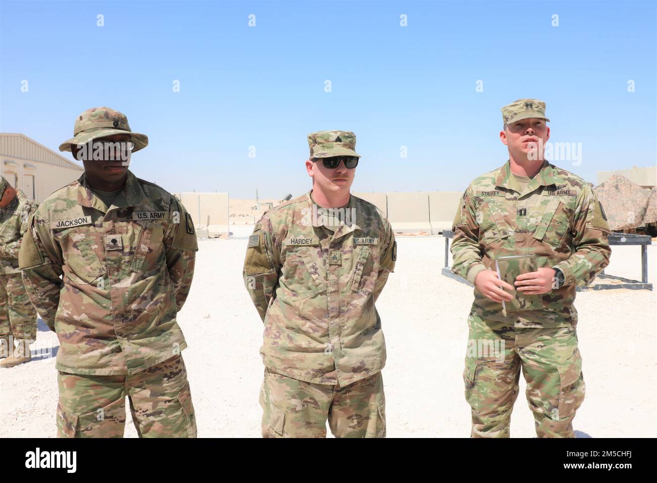 (left to right) Spc. Jackson and Sgt. Hardey stand at ease while Capt ...