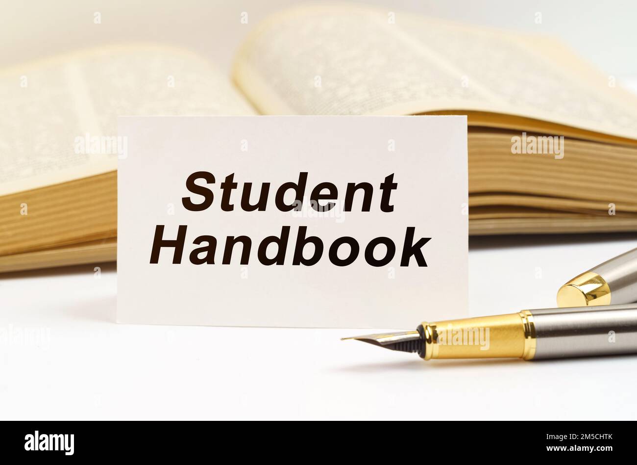 Education concept. Against the background of the book lies a pen and a ...