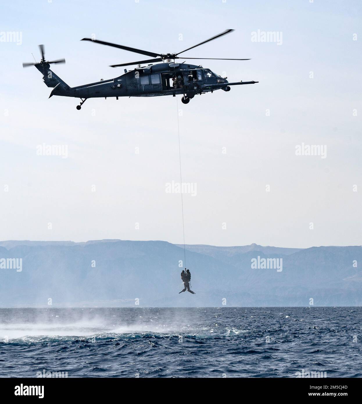 An HH-60G Pave Hawk helicopter hoists a Royal Jordanian Navy Frogman ...