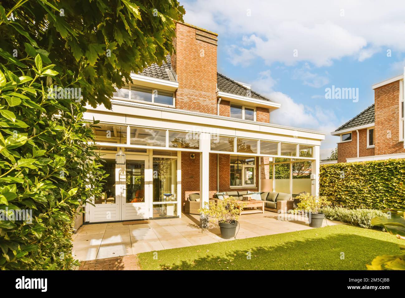 the outside of a house with green grass and trees in the front yard, as ...