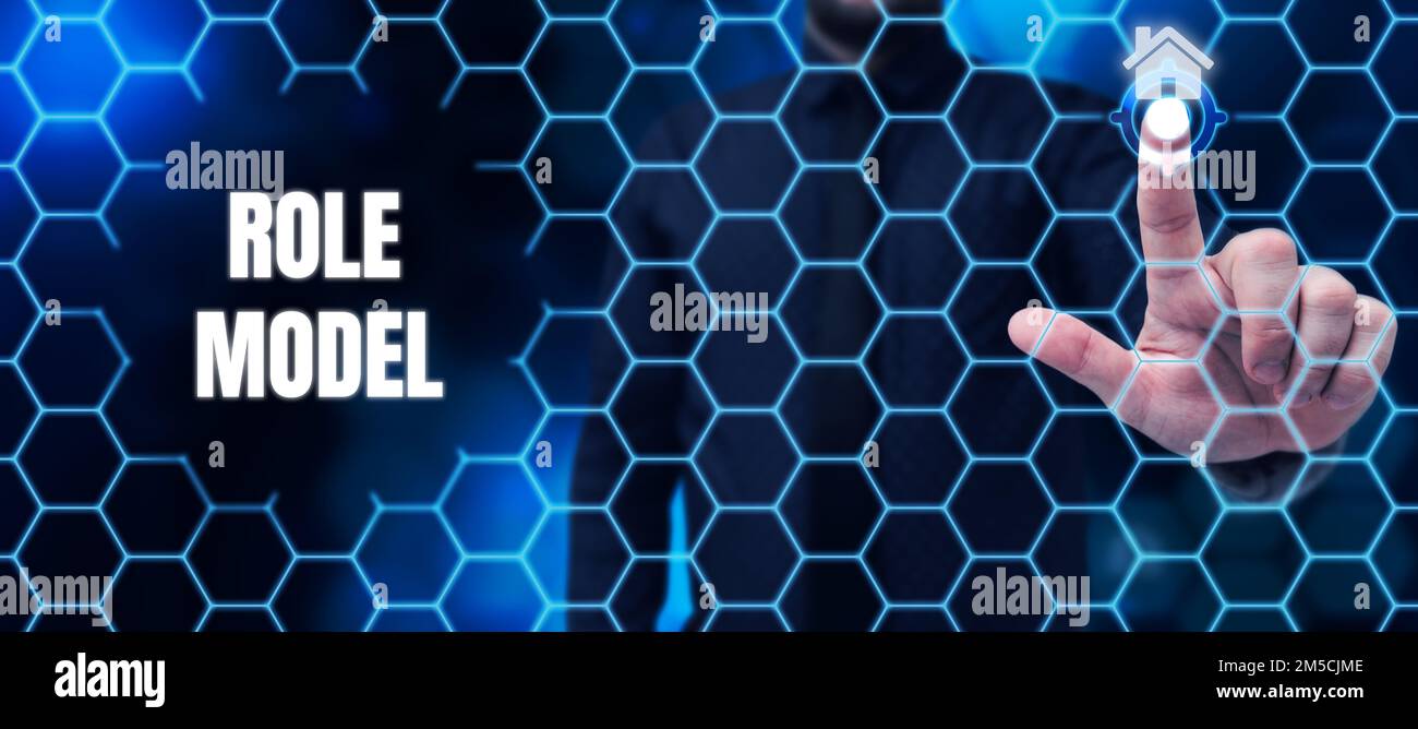 Text sign showing Role Model. Word Written on a person looked to by others as an example to be ...