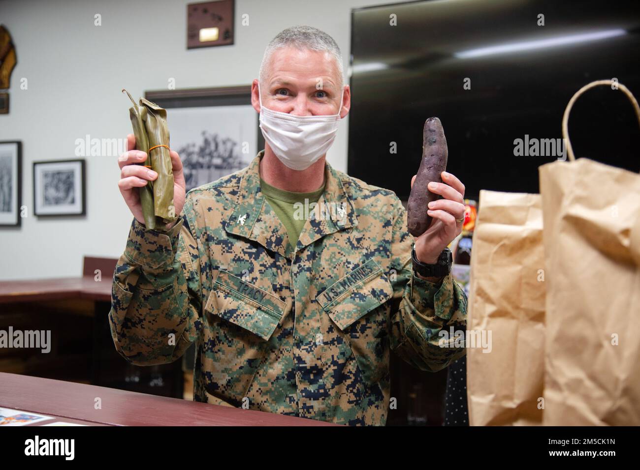Col. Matthew W. Tracy expresses his joy as he receives a gift of ...