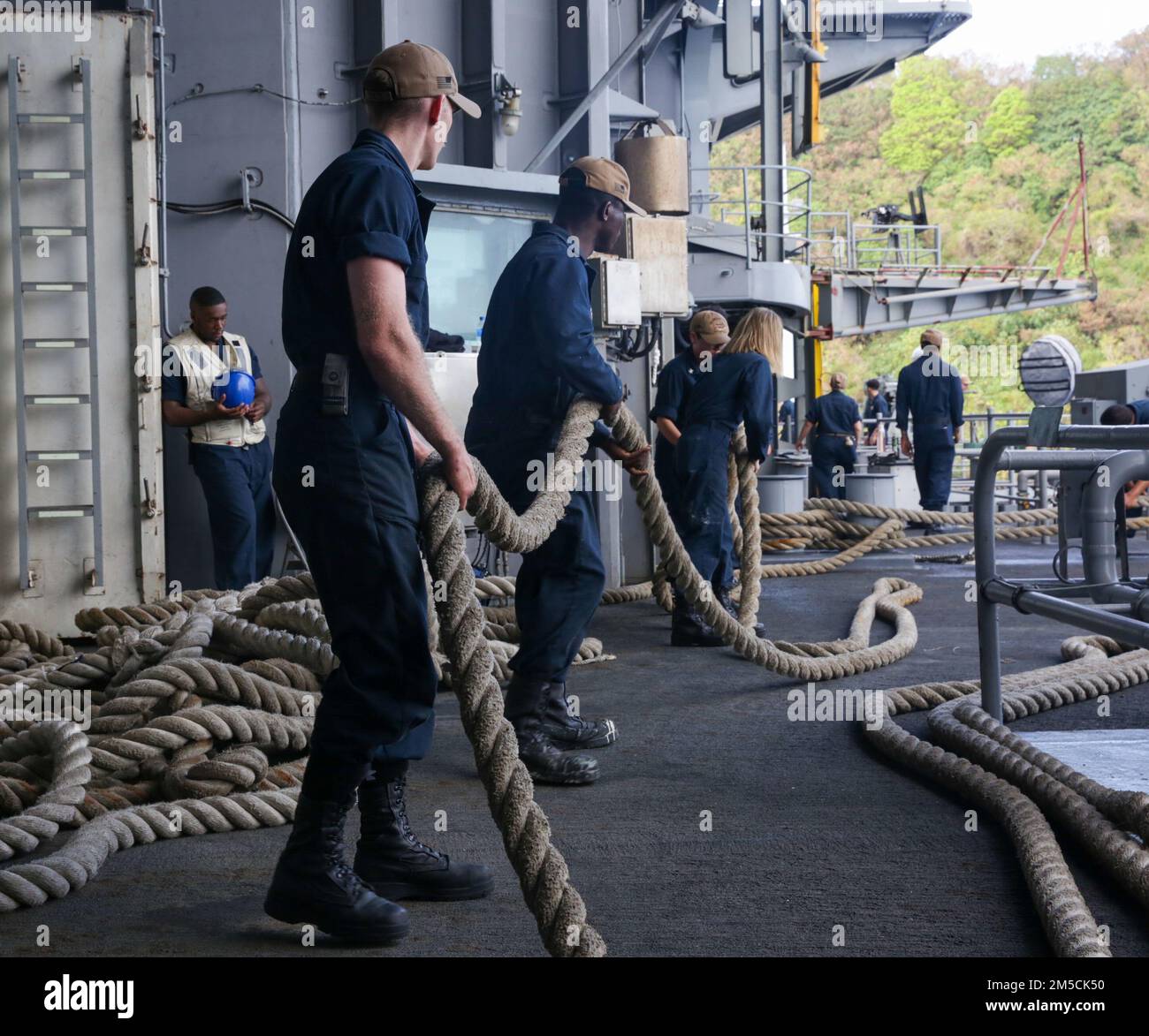 NAVAL BASE GUAM (March 2, 2022) Sailors handle line on the fantail as ...
