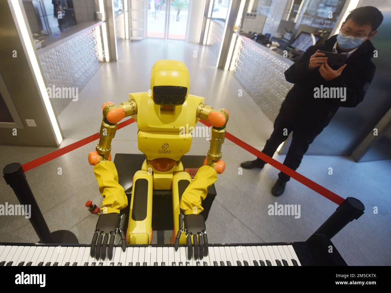 HANGZHOU, CHINA - DECEMBER 28, 2022 - A robot "Xiao Le" plays piano for ...