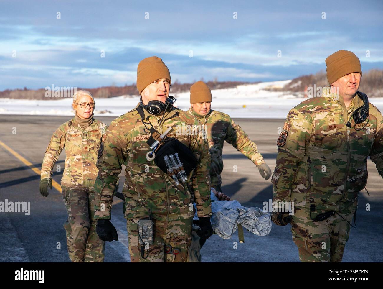 Critical care air transport team (CCATT) personnel load a simulated ...
