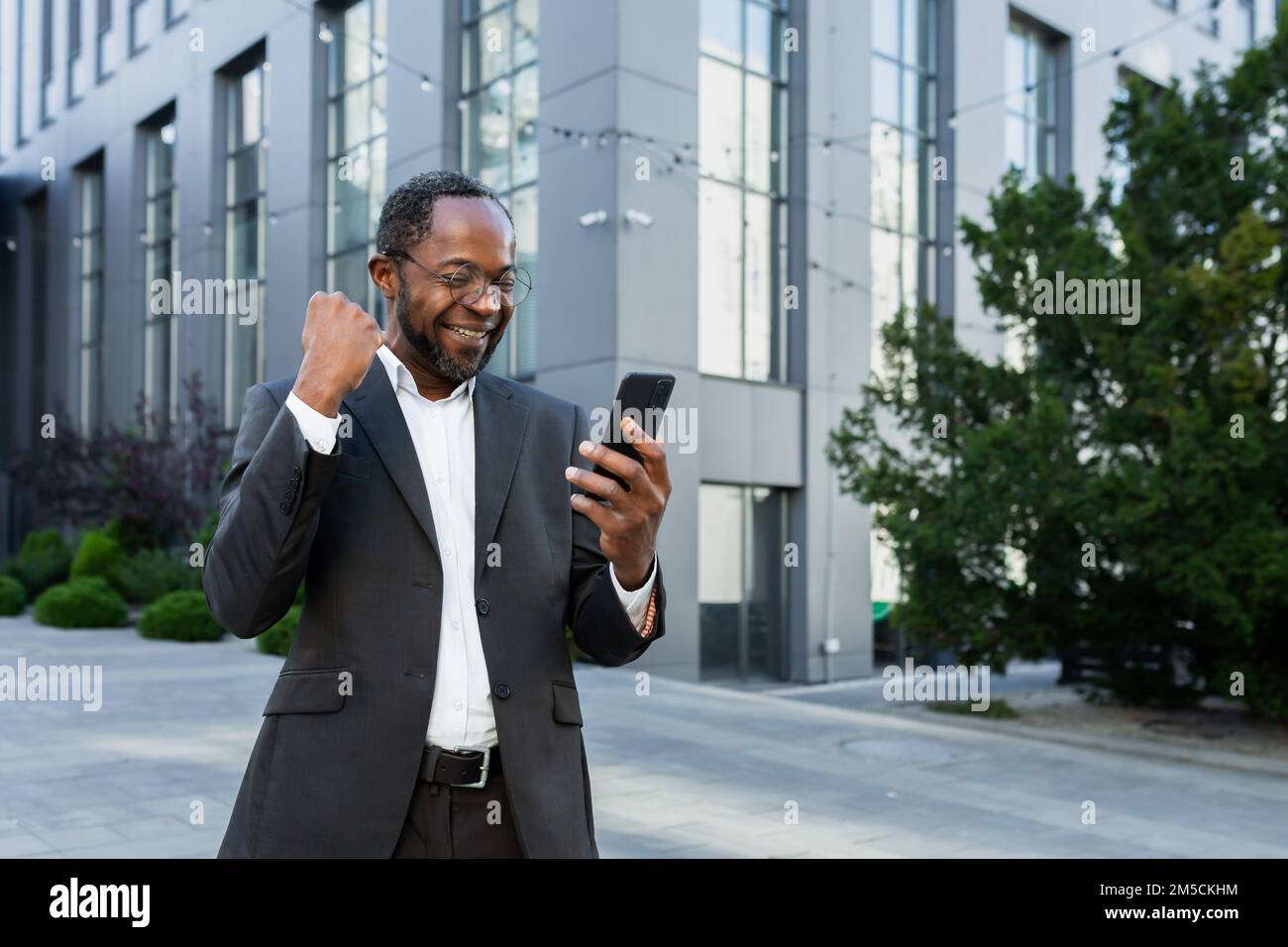 African american businessman boss outside modern office building using ...