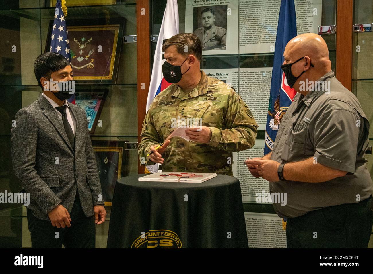 Lt. Gen Willard Burleson, commanding general of Eighth Army, hands his ...