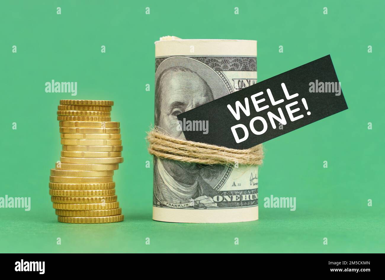 Business concept. On a green surface are coins and dollars in a bundle ...