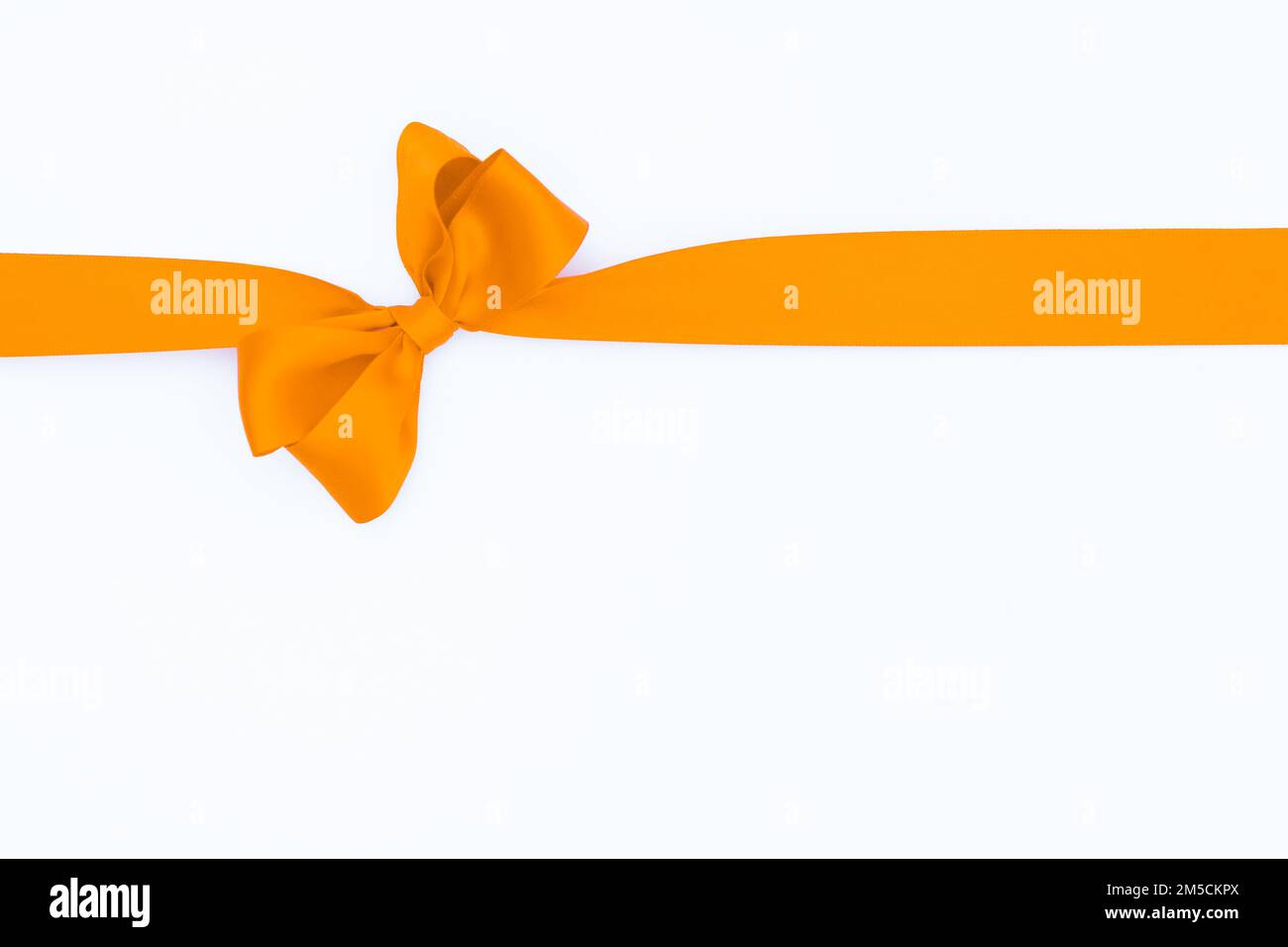 Satin ribbon bow for gift box in yellow color, isolated on white ...