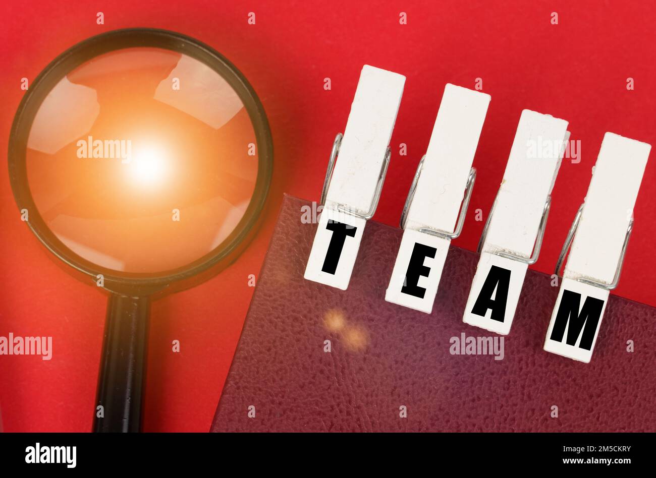 Business concept. On the red surface there is a magnifying glass, a ...