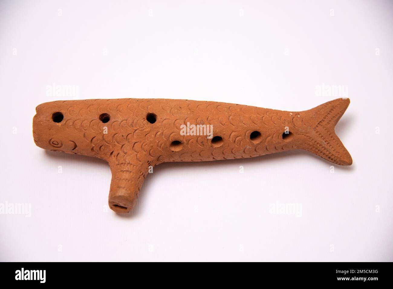 A closeup of an ocarina old wind musical instrument made of clay on a ...