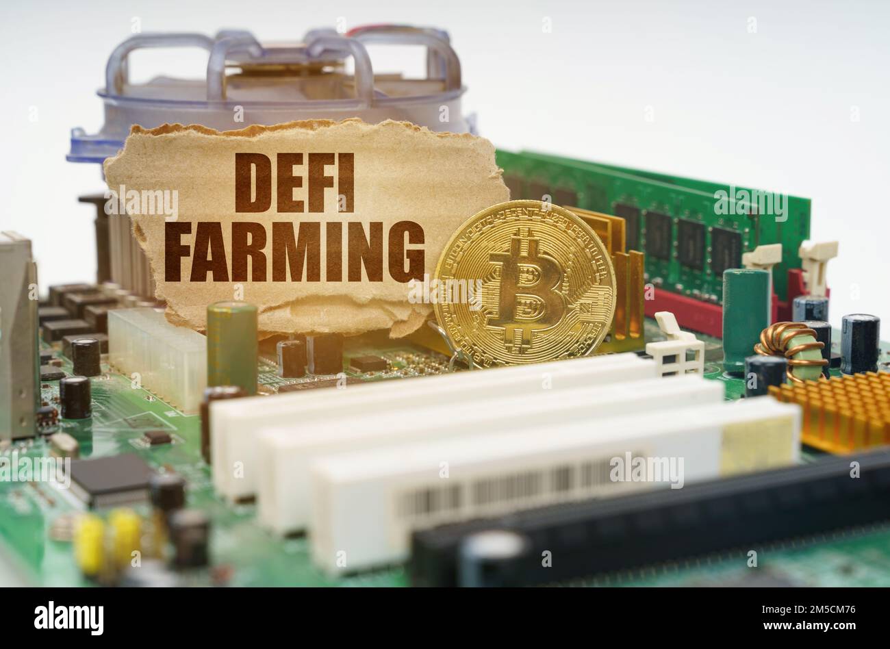Crypto - business concept. On the motherboard lies a bitcoin coin and a ...