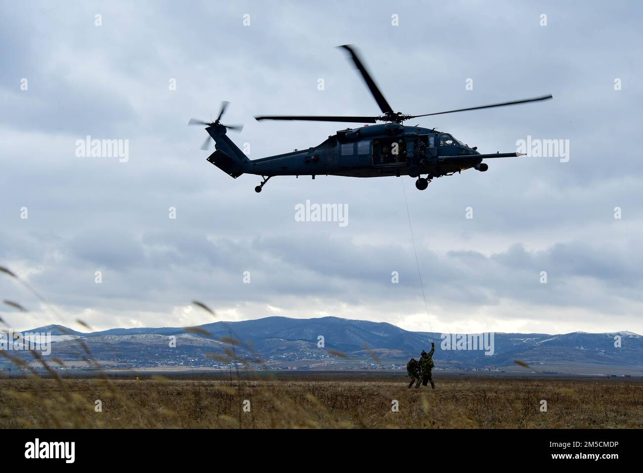 Pararescueman assigned to the 57th Rescue Squadron prepare to hoisted into an HH-60G Pave Hawk ...