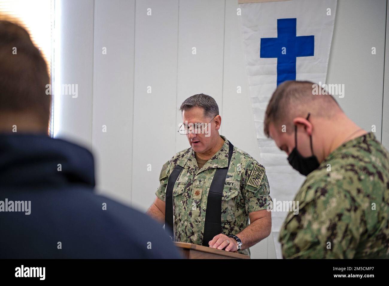Lt. Cmdr. David Pahs, a chaplain, prays during an Ash Wednesday service ...