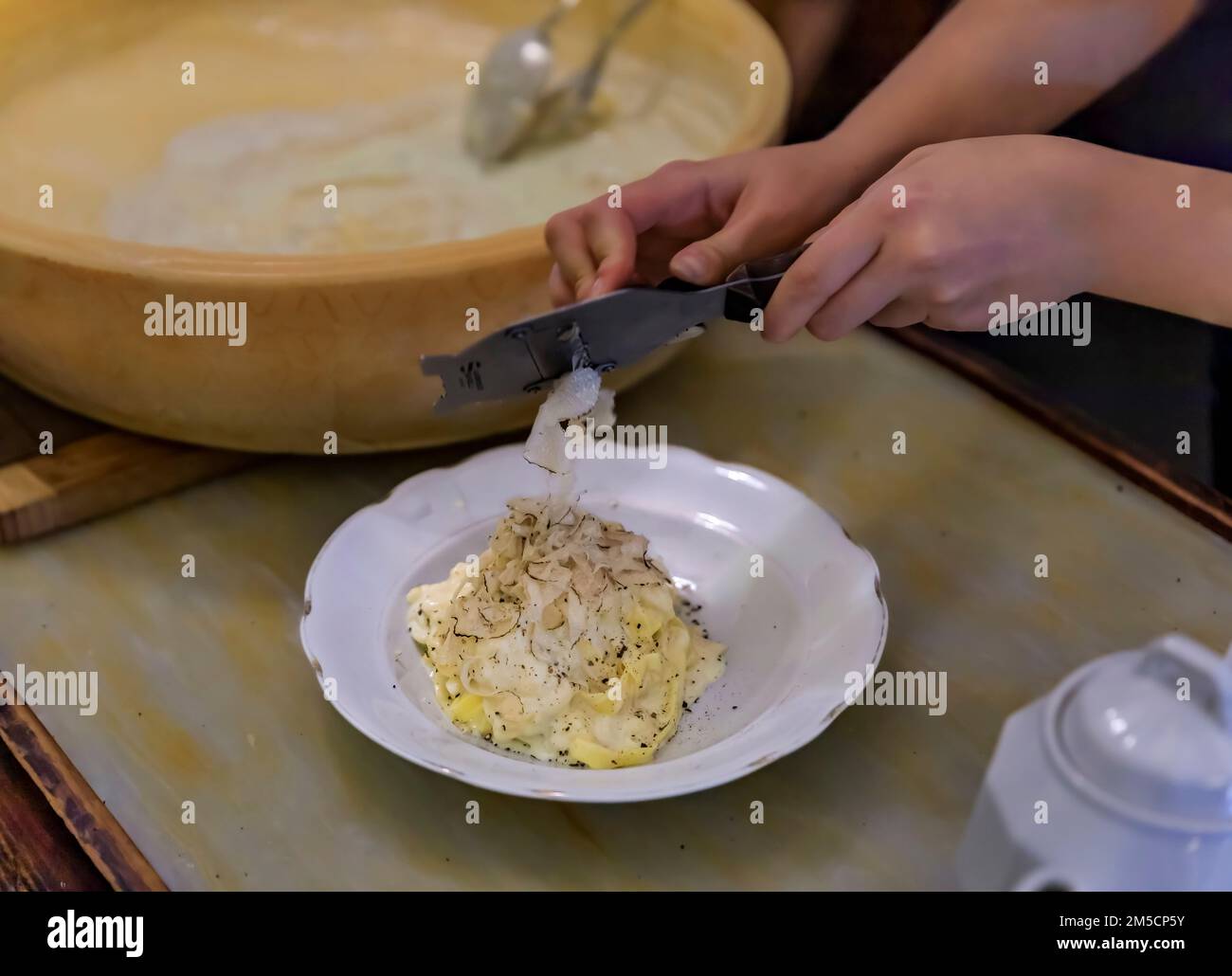 Fresh pasta with truffle sauce, cooked in a pecorino cheese wheel with ...