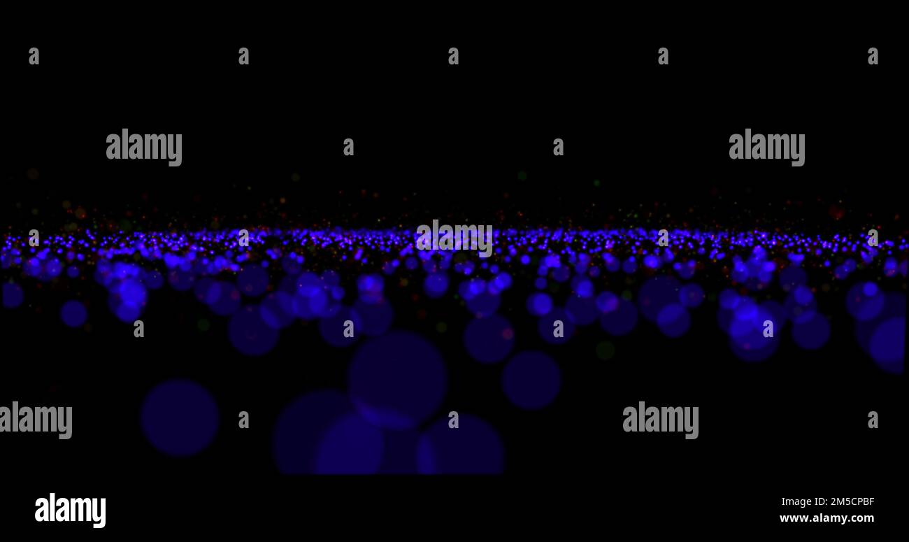 Flying luminous particles of different sizes on a black background ...