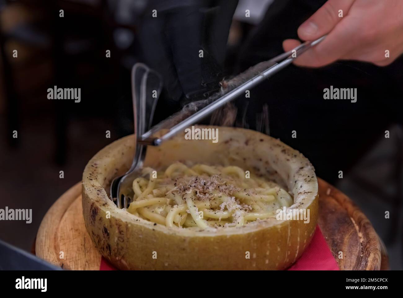 Fresh pasta with truffle sauce, cooked in a pecorino cheese wheel with ...