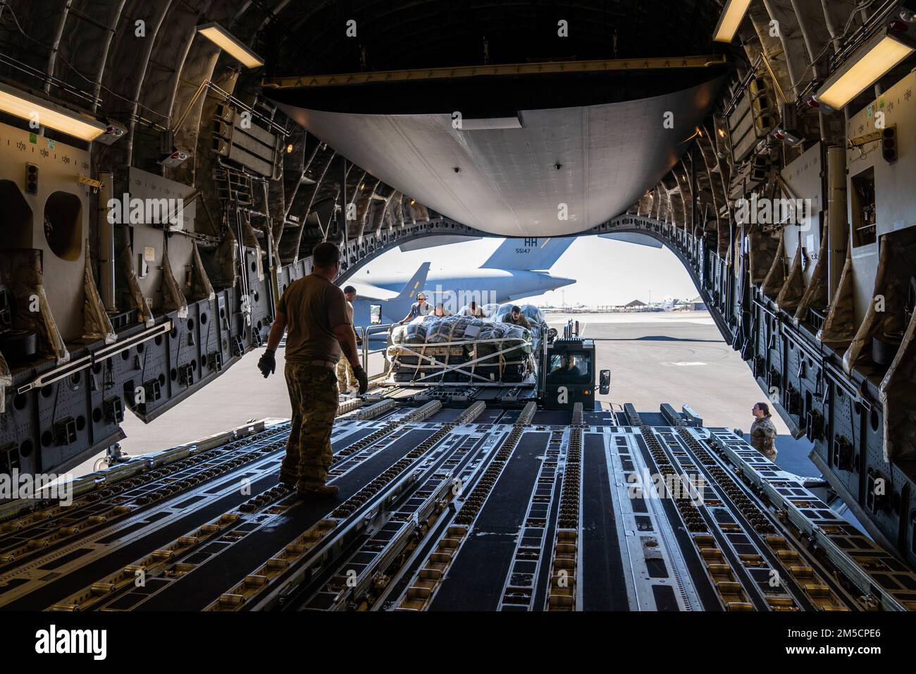 Airmen from the 535th Airlift Squadron work alongside the 647th ...