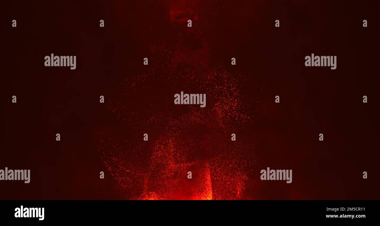 A vortex of red particles rising up on a dark red background. Bokeh ...