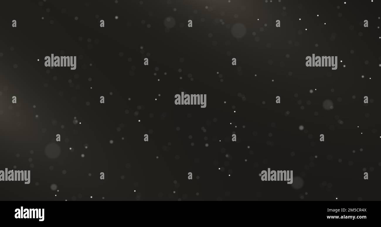 Slowly moving particles in yellowish light. Falling snow in the light ...