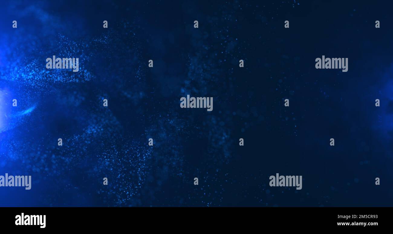 A vortex of blue particles slowly unfolding against a blue background ...