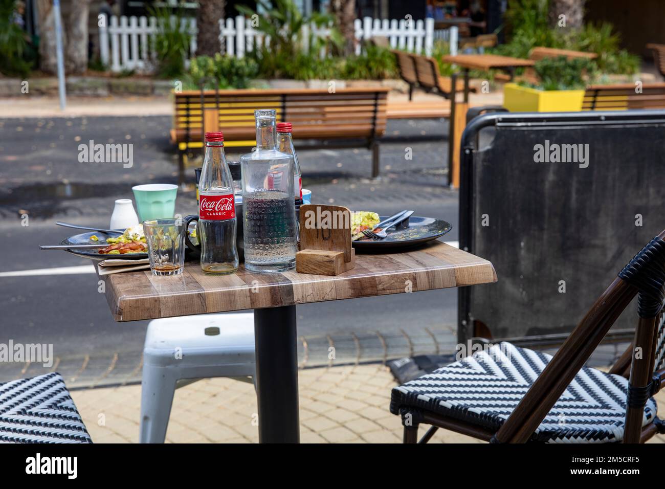 Breakfast table at a cafe in Avalon Beach Sydney with leftover food ...
