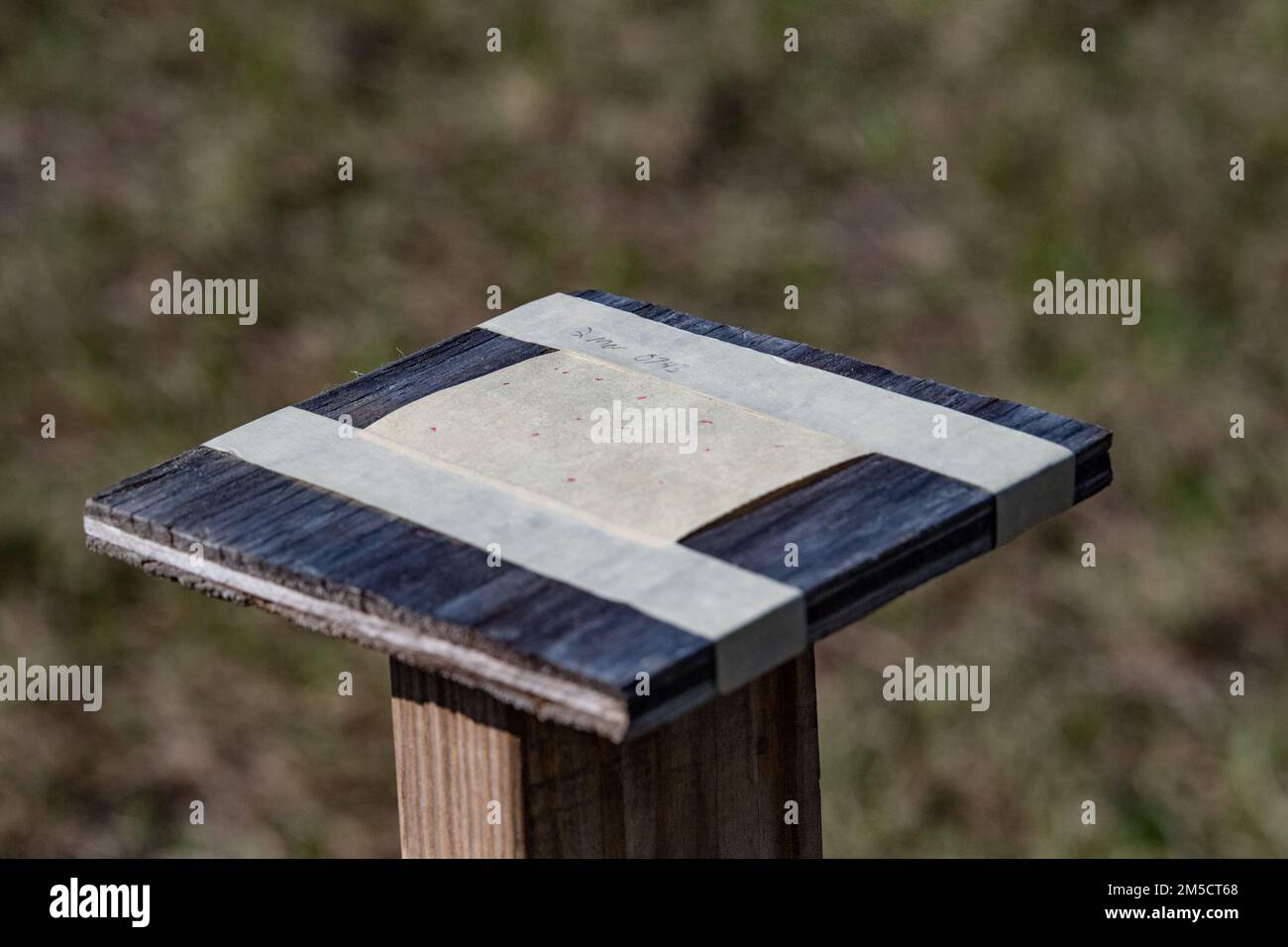 A piece of M8 Chemical Detection Paper is marked with red dots ...