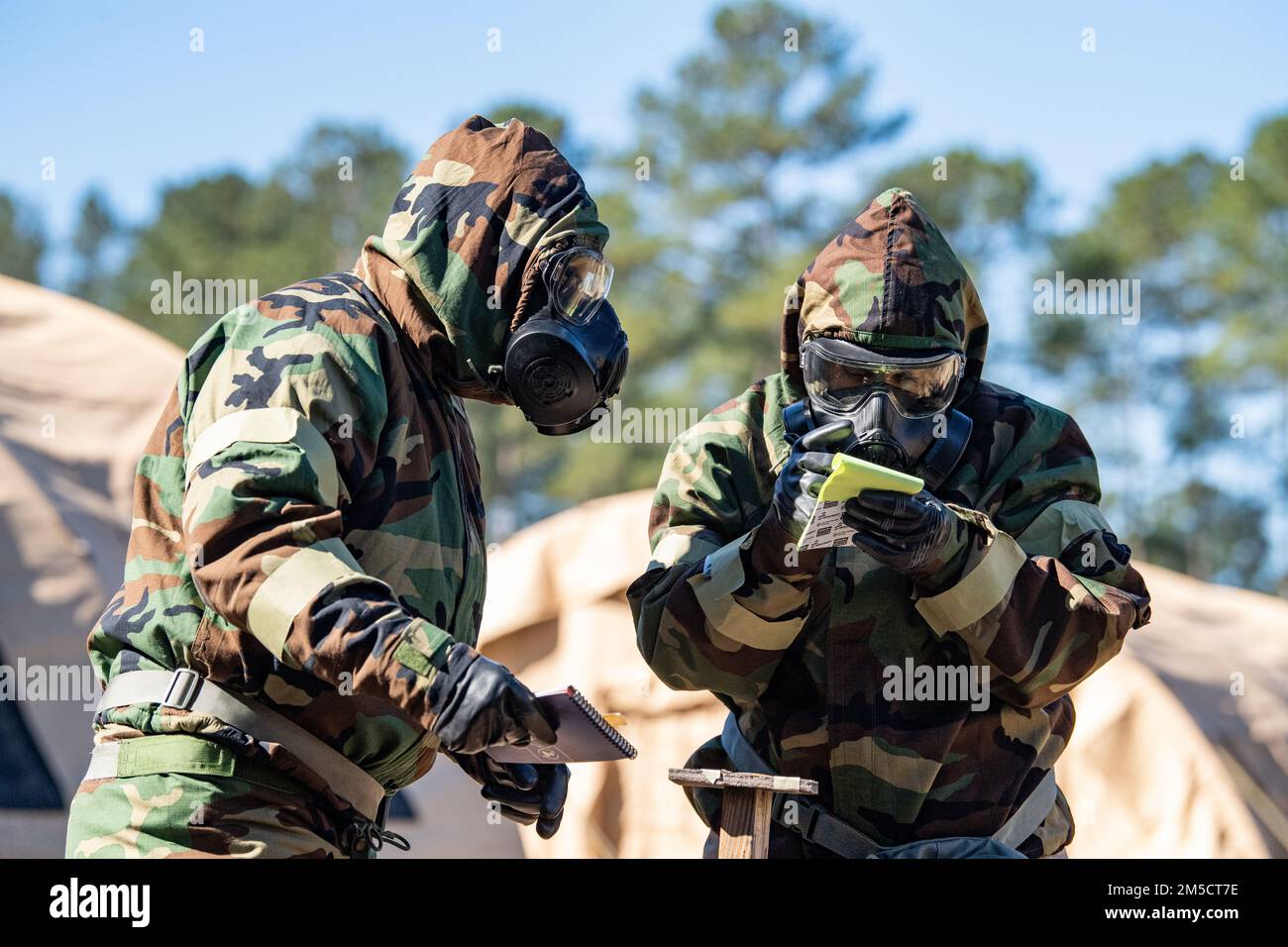 A post-attack reconnaissane (PAR) team checks the M8 Chemical Detection ...