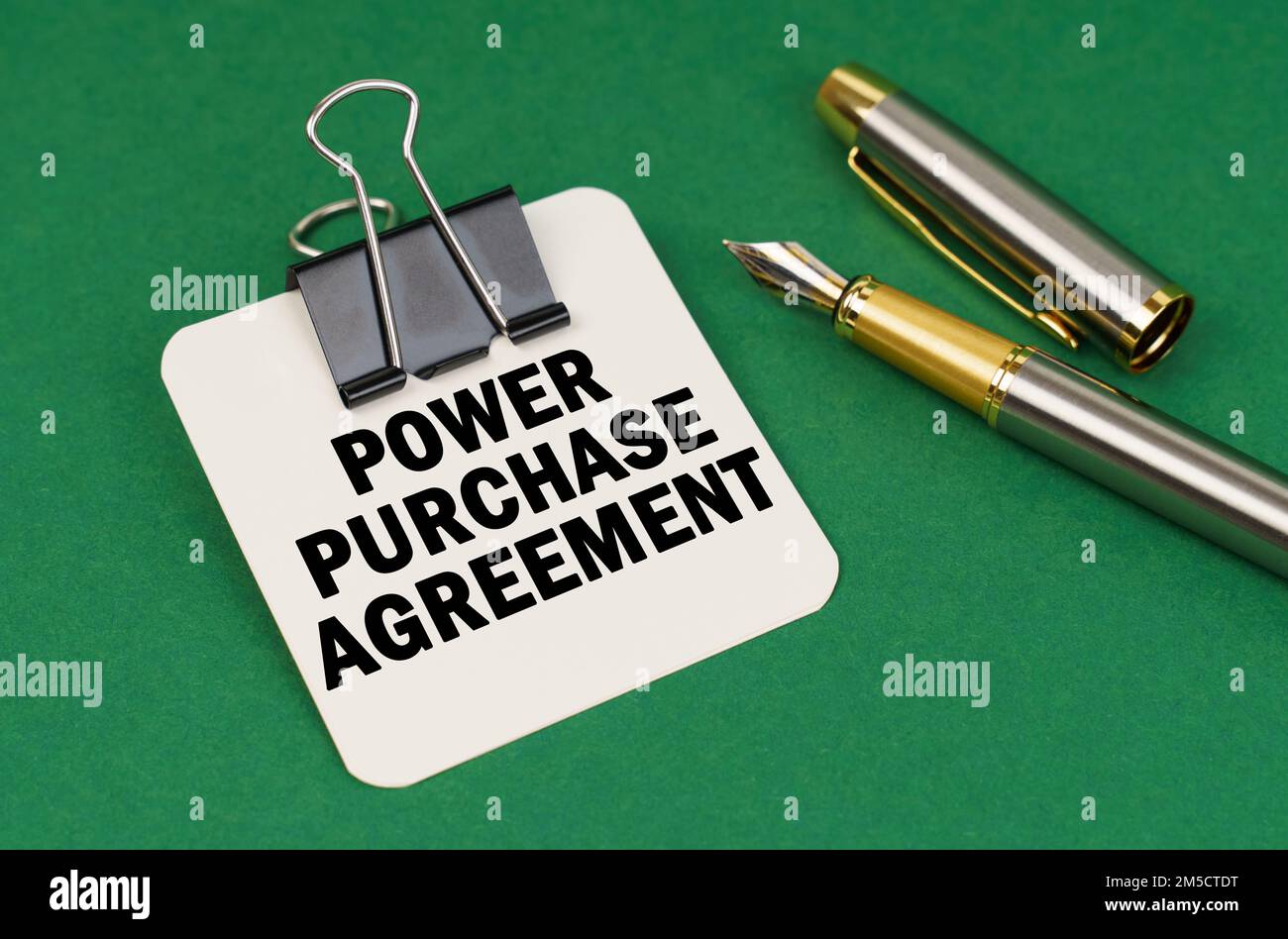 Business and industry concept. On a green surface, a pen and a sheet of ...