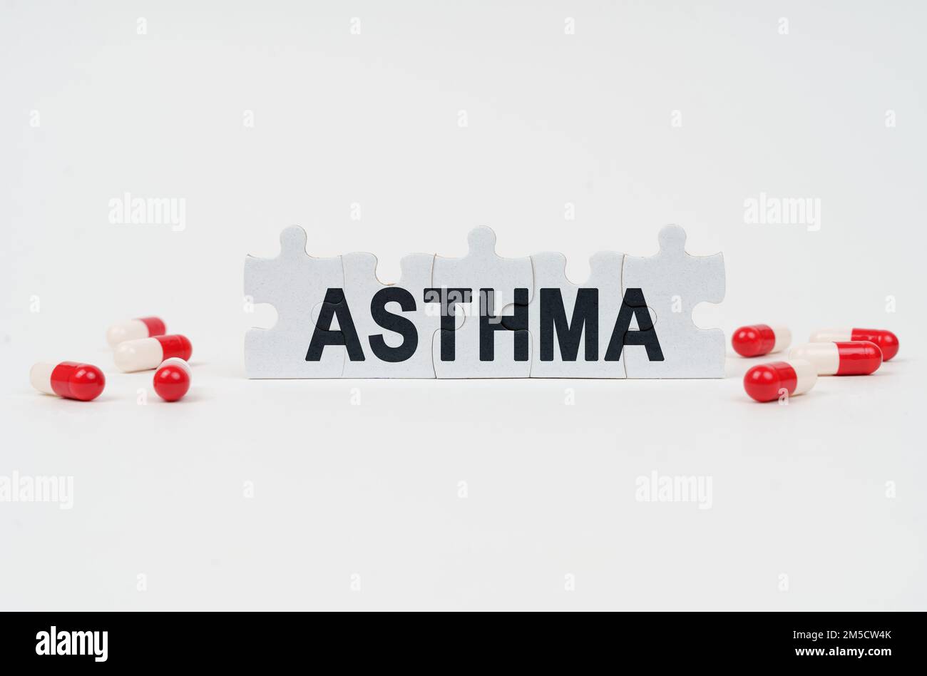 Medical concept. On a white surface are tablets and puzzles with the ...