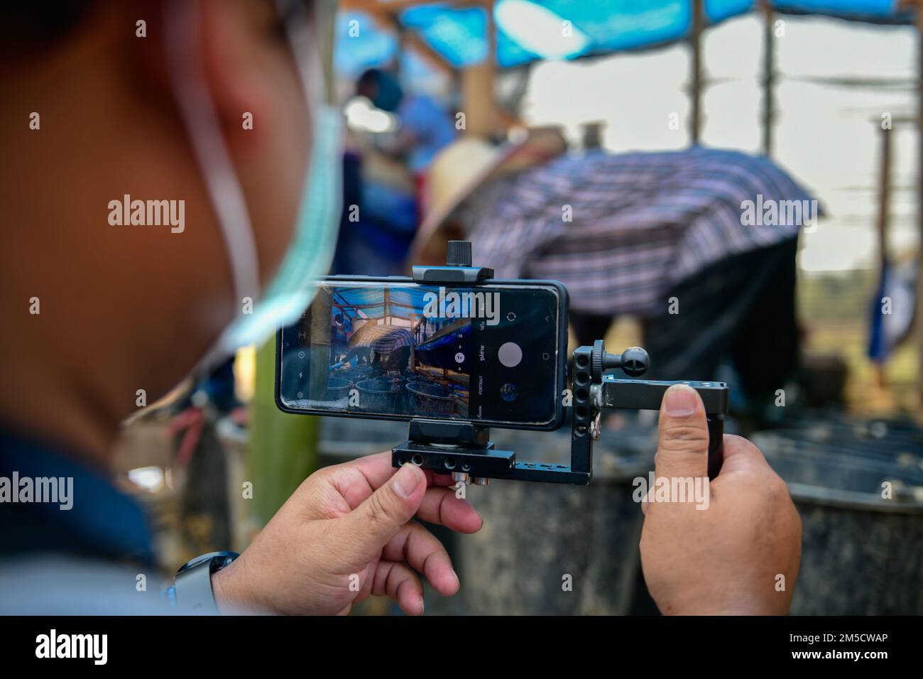 A Thai PBS television station crew member films a documentary about the ...