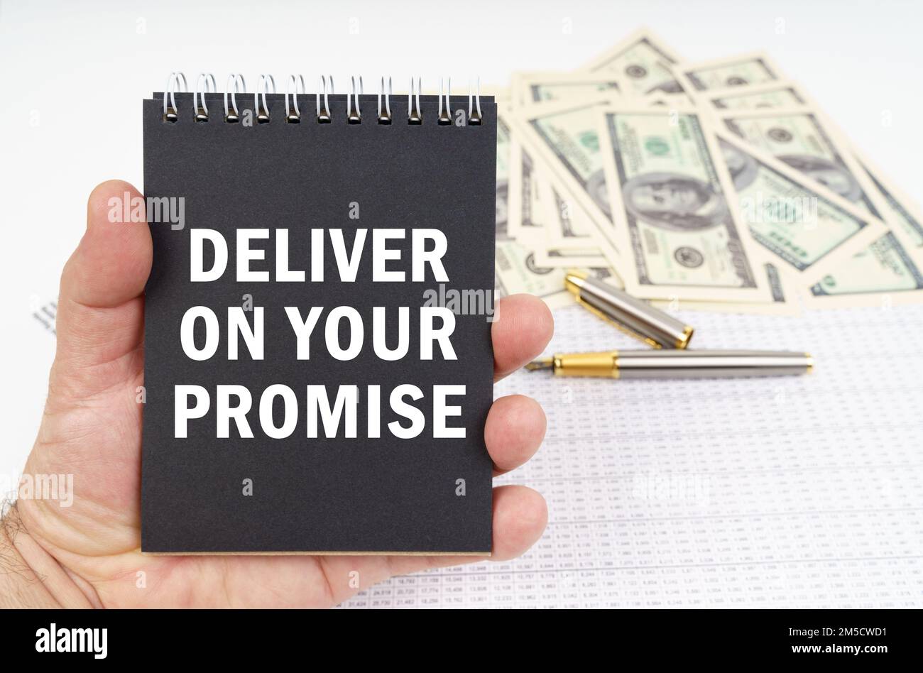 Business concept. In the man's hand is a notepad with the inscription ...