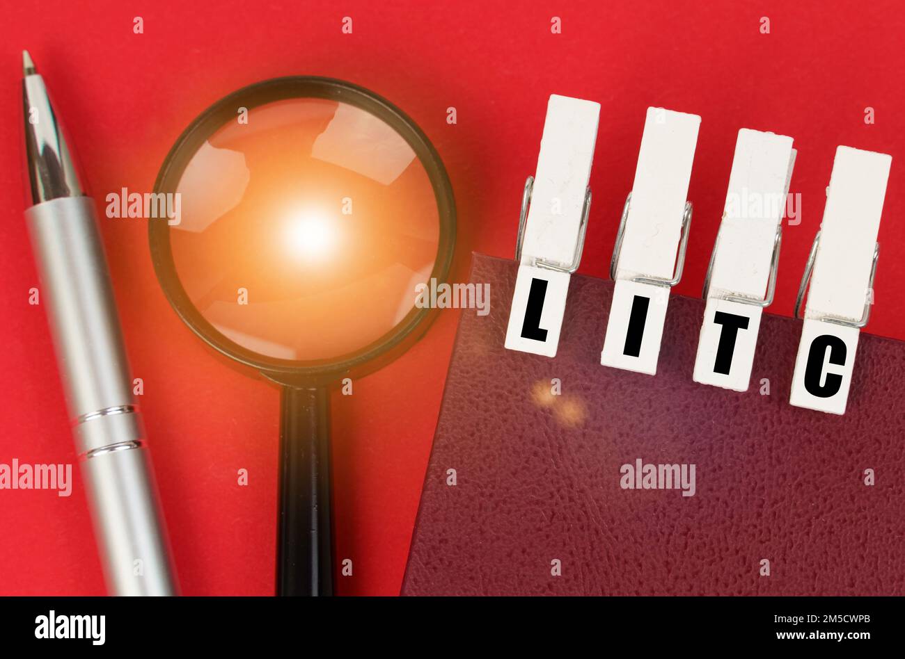 Business concept. On the red surface there is a magnifying glass, a ...