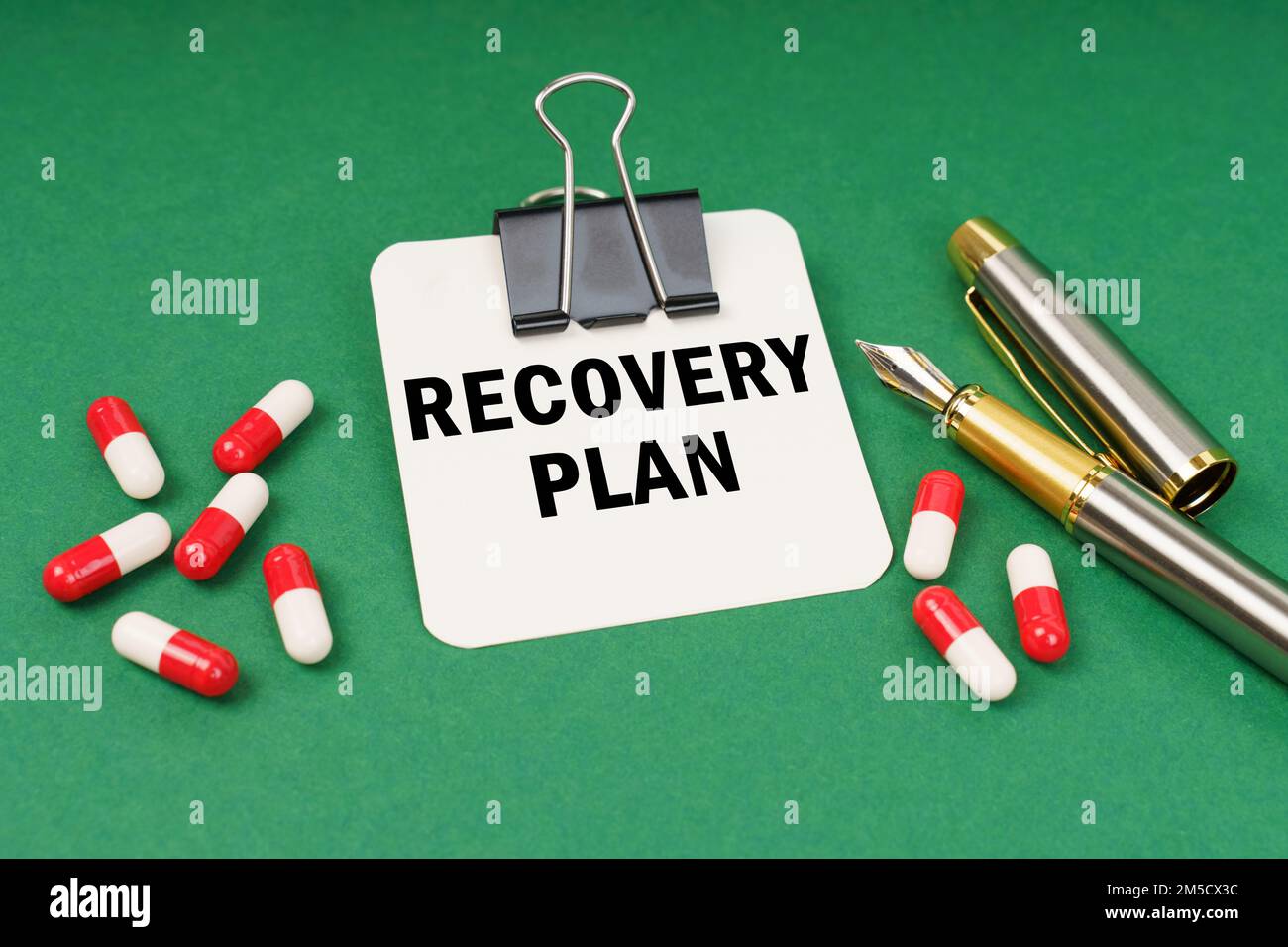 Medical concept. On the green surface of the tablet, a pen and a ...