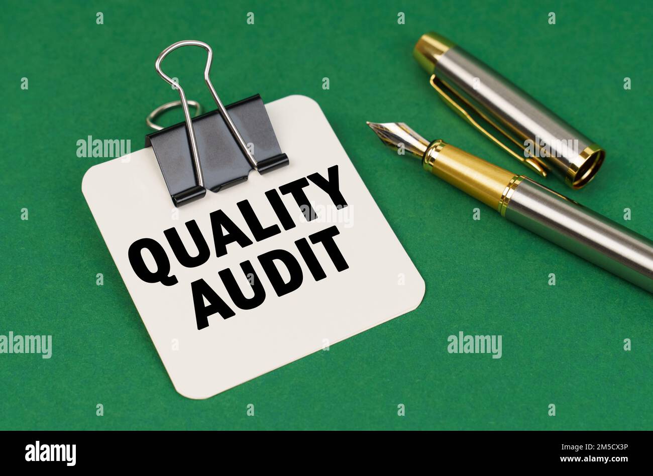 Business and industry concept. On a green surface, a pen and a sheet of ...