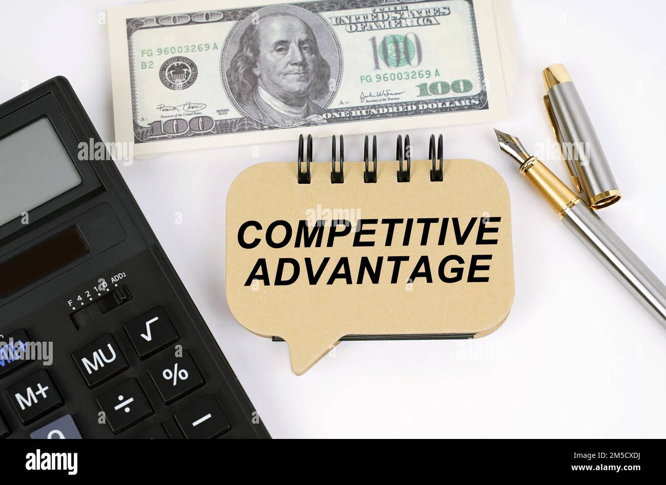 Business concept. On a white surface, a calculator, dollars, a pen and ...