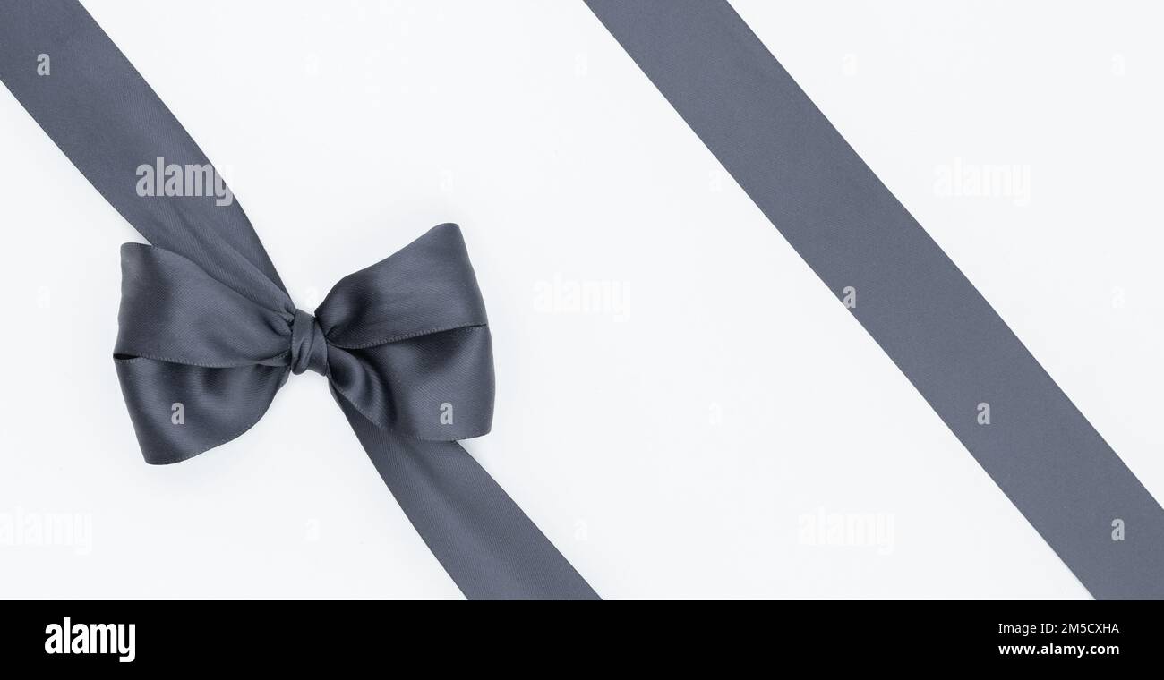 Satin ribbon bows for gift pack in gray color, isolated on white ...