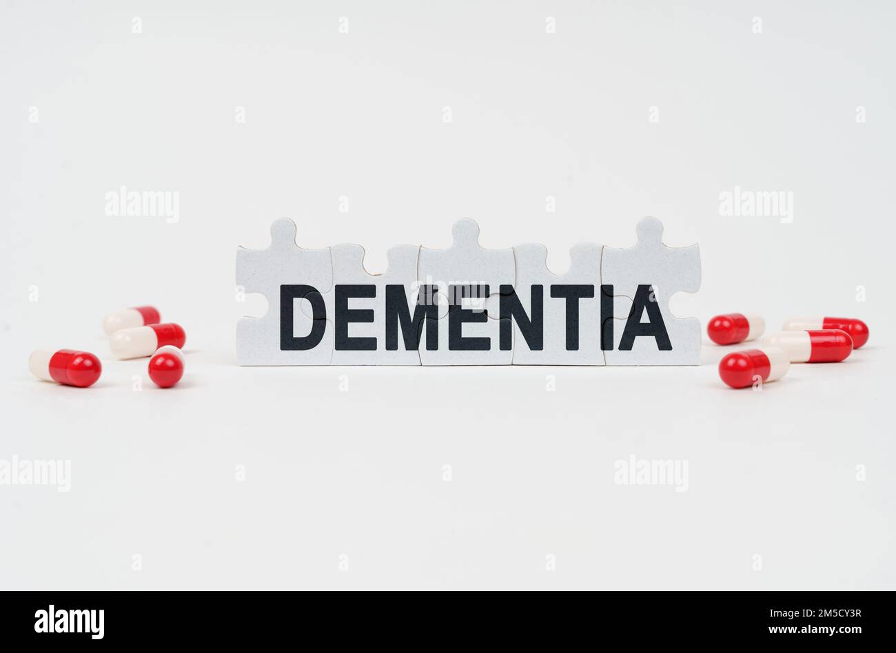 Medical concept. On a white surface are tablets and puzzles with the ...