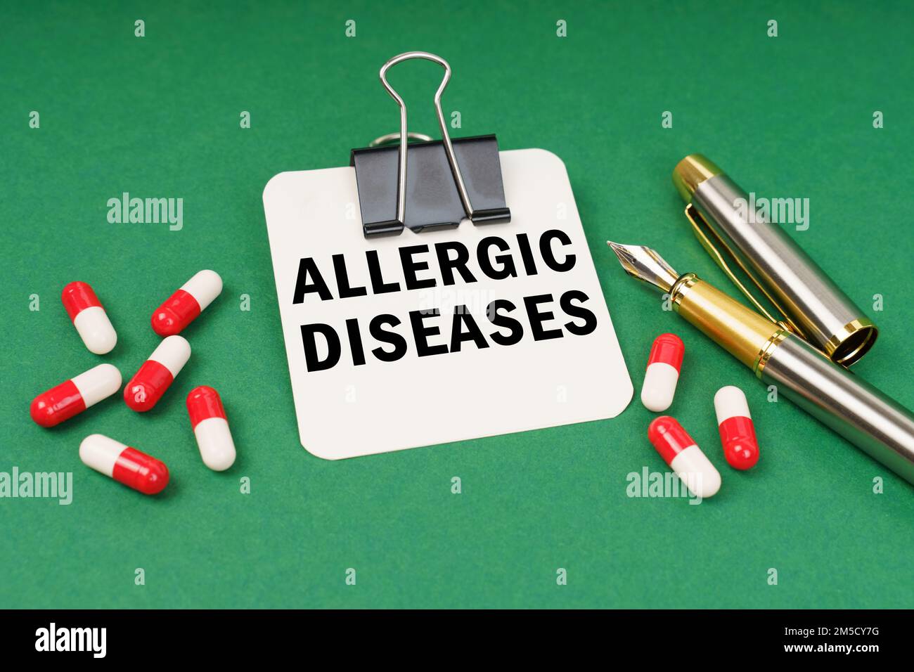 Medical concept. On the green surface of the tablet, a pen and a ...