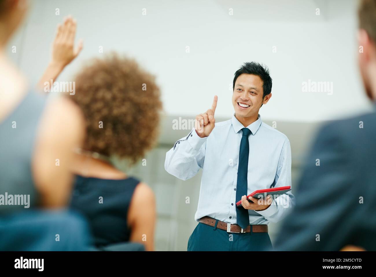 Im open to any questions. a businessman holding a digital tablet while ...