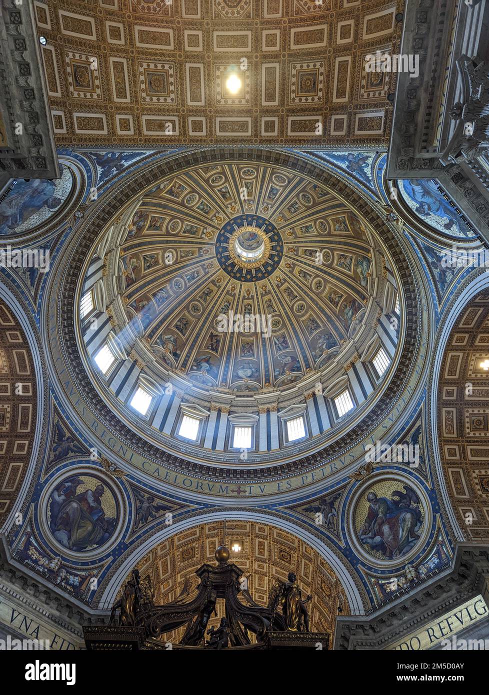 A vertical shot of the golden dome inside the Saint Peter's basilica in ...