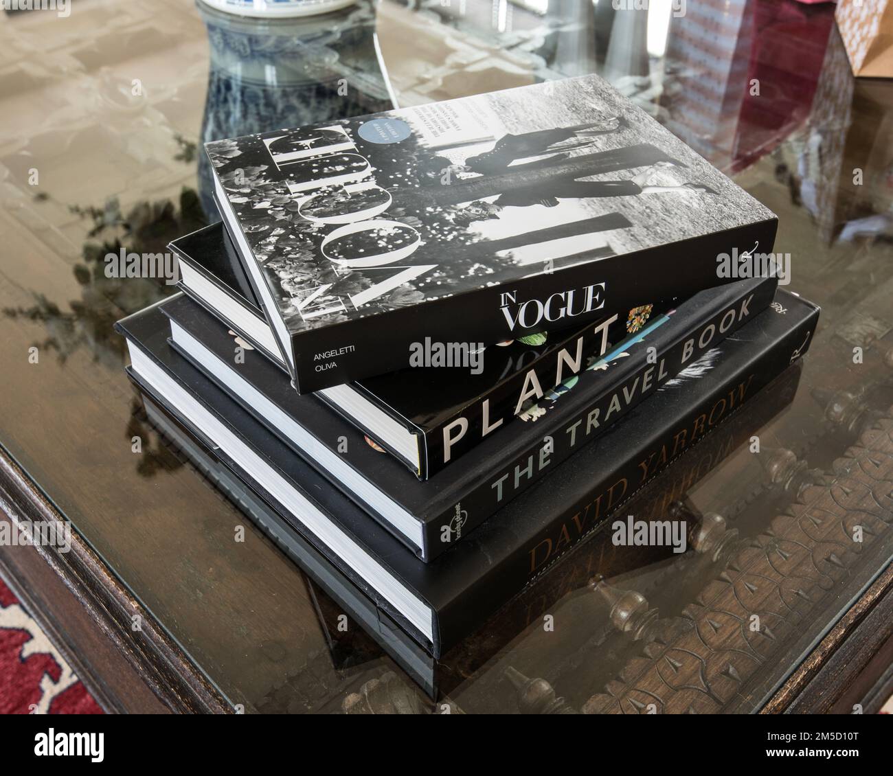 Both stylish and statement books on top of a bespoke glass-topped table ...