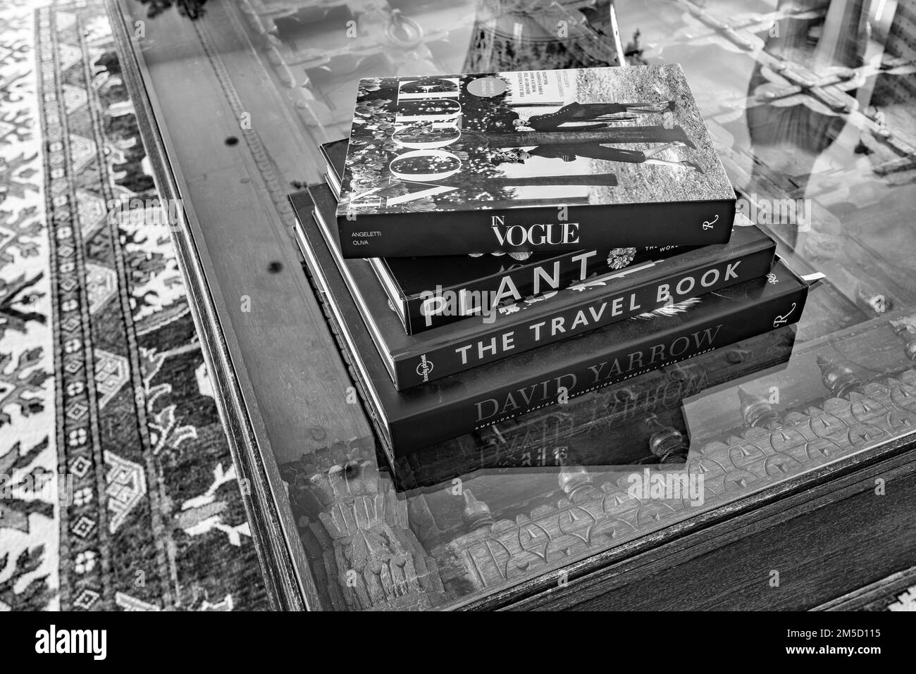 Both stylish and statement books on top of a bespoke glass-topped table ...