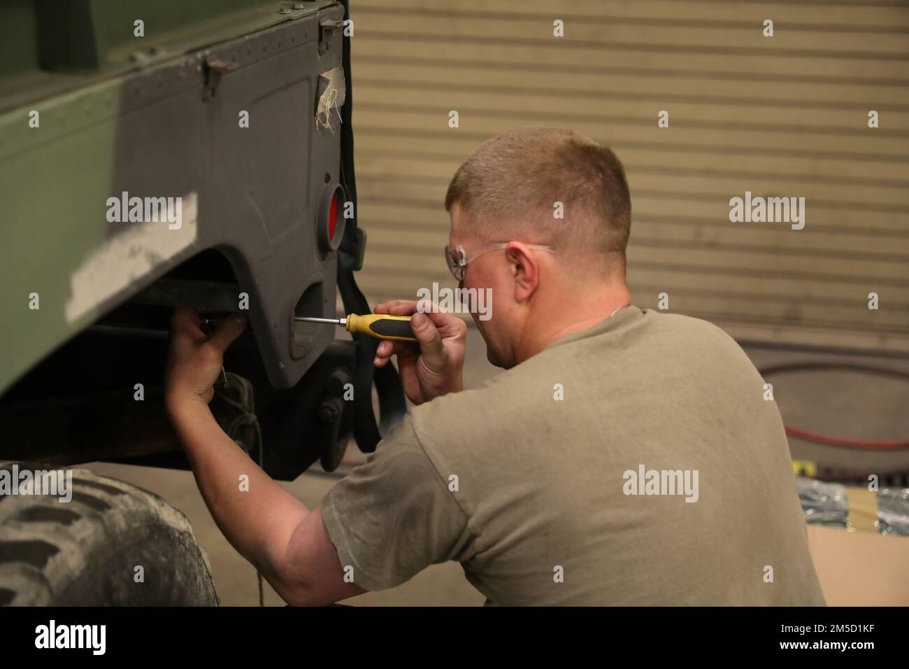 A Soldier from the 223rd Ordnance Company (ORD CO) repairs a Tactical ...